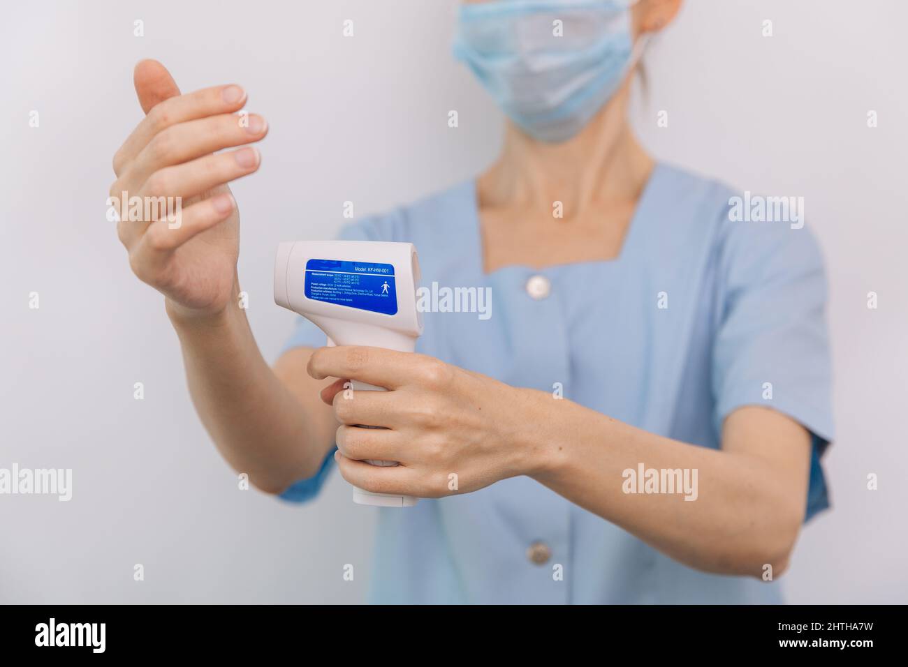 Temperature measurement gun in doctor hands. Close-up shot of doctor ...