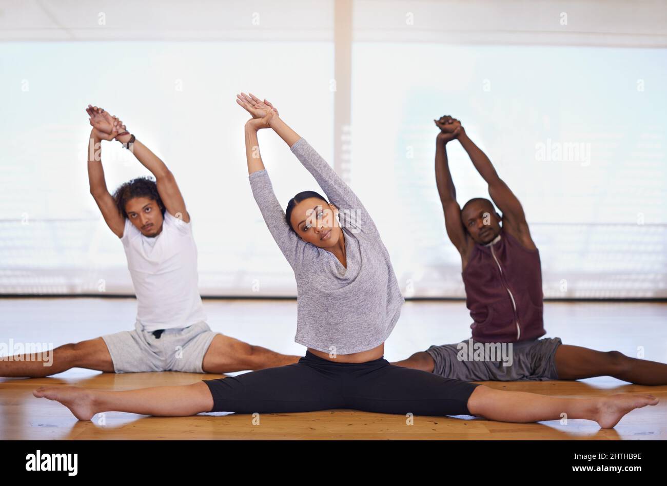 Focused on staying flexible. Shot of a group of young dancers ...