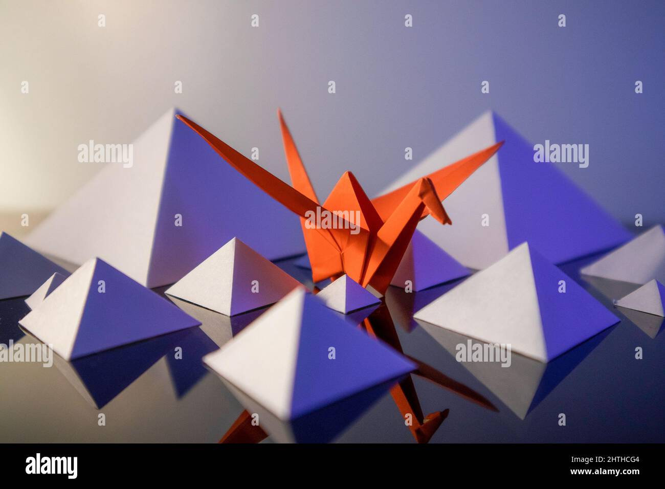 Origami pyramids on reflective glass Stock Photo - Alamy
