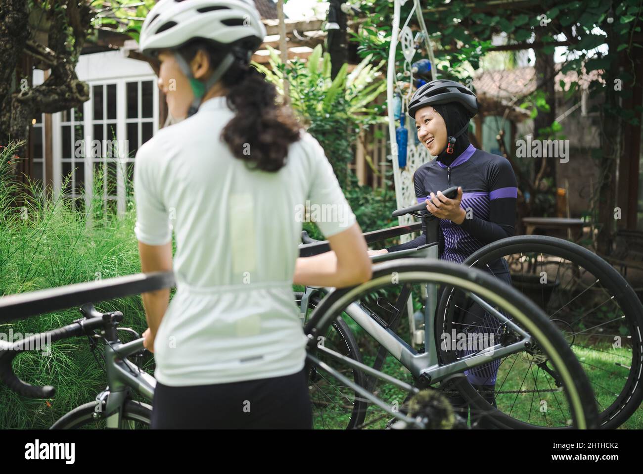 female cyclist hang their bike at the bike rack Stock Photo - Alamy