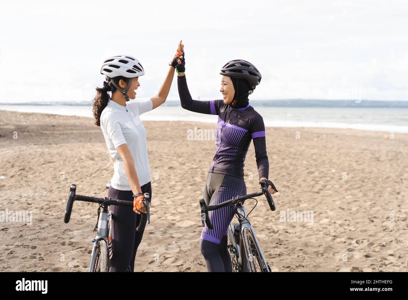 asian two cyclist friend high five when finish their race Stock Photo ...