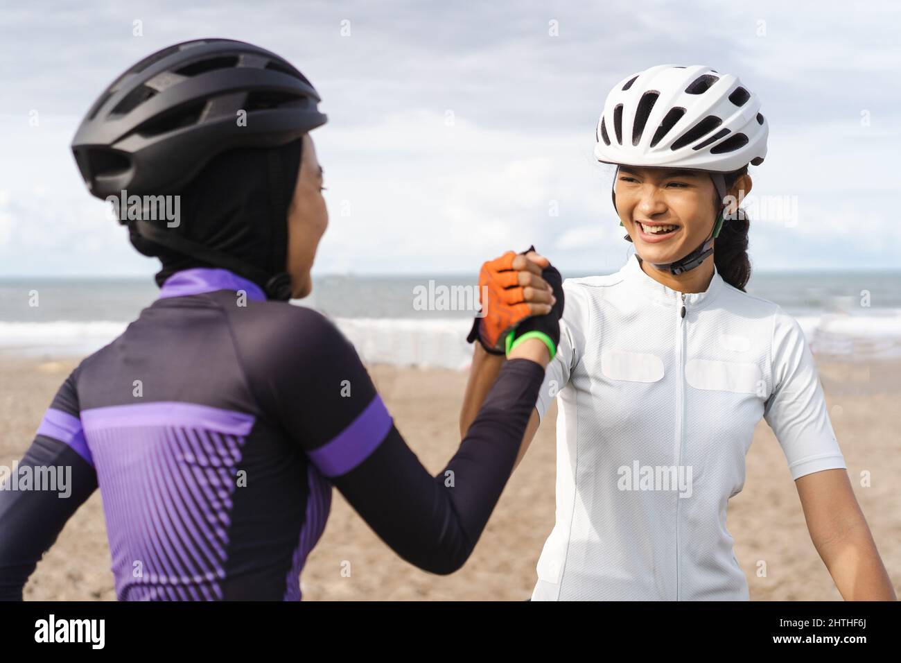 asian two cyclist friend high five when finish their race Stock Photo ...
