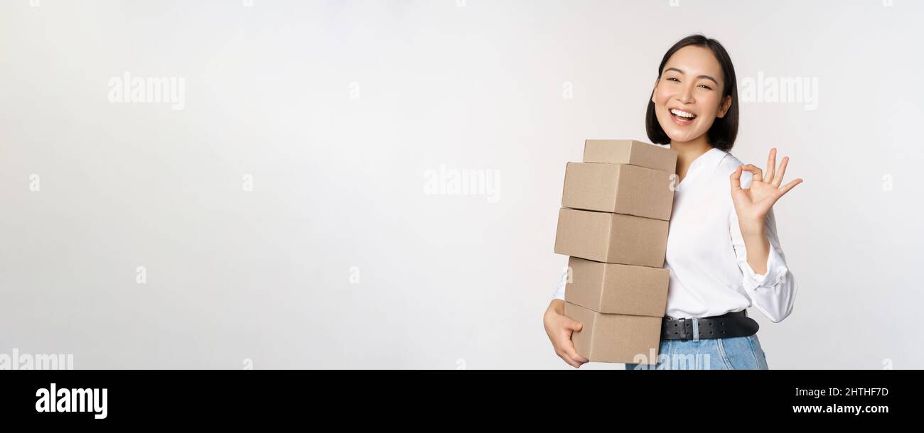 Portrait of beautiful happy woman carry boxes with orders ...