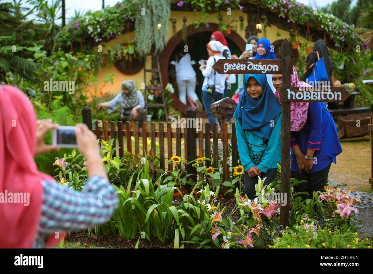 Friends excited and taking photo with the hobbiton house replica during ...