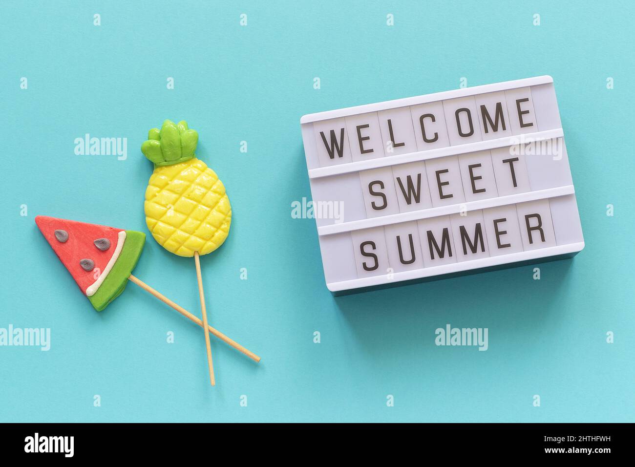 Welcome sweet summer text on light box, pineapple and watermelon ...