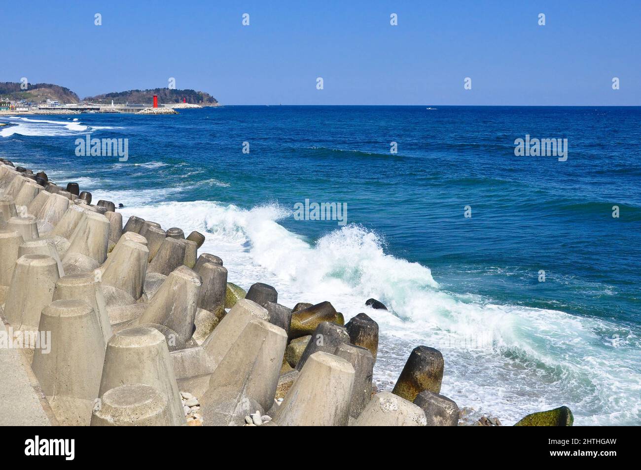 Coastline with concrete wave breaker Stock Photo - Alamy