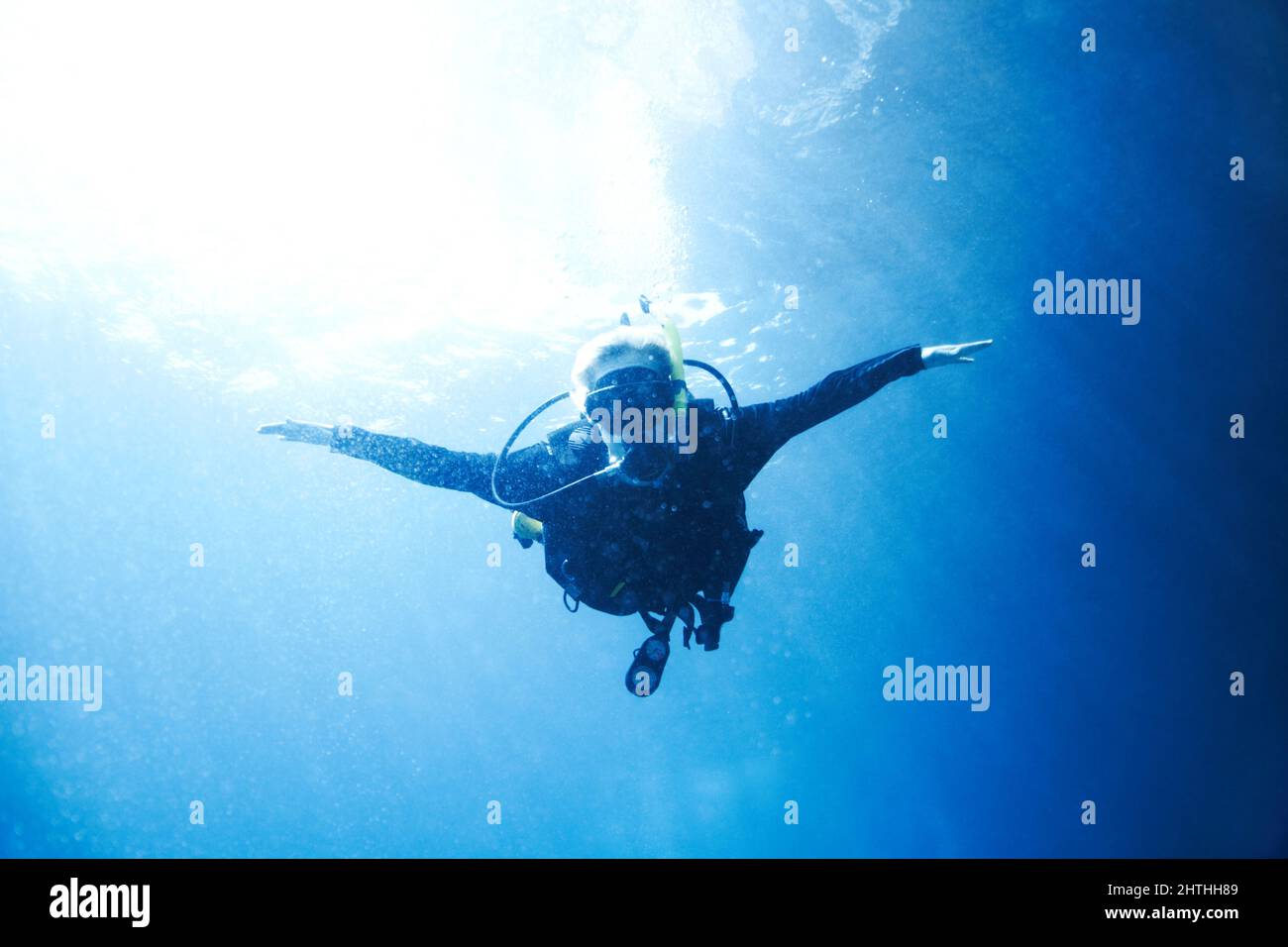 Soaring in the ocean depths. A scuba diver descending towards you with ...
