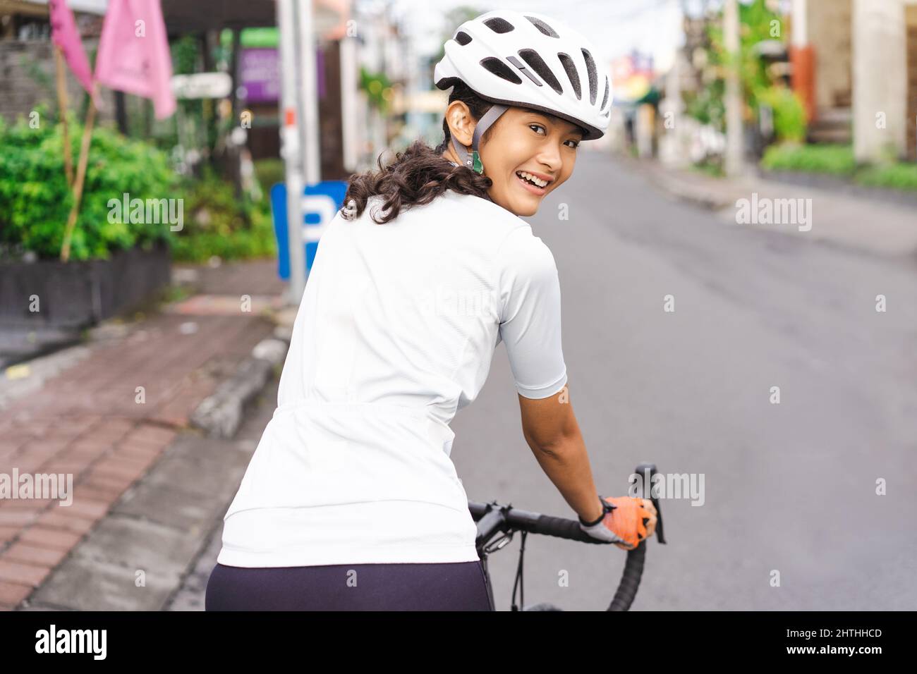 Female cyclist from behind with helmet hi-res stock photography and ...