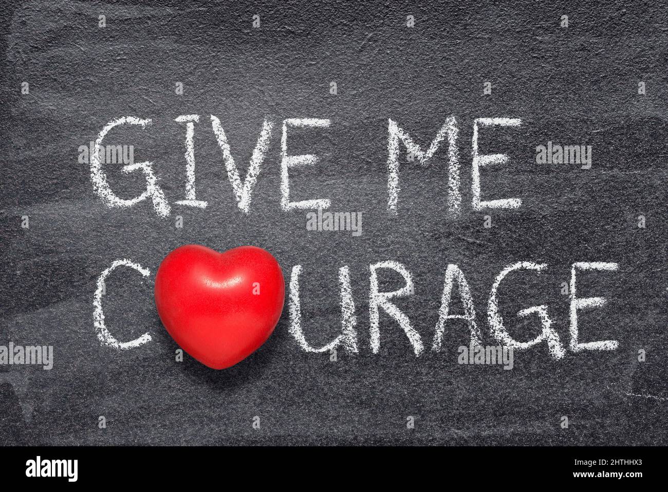 give me courage slogan written on chalkboard with red heart symbol ...