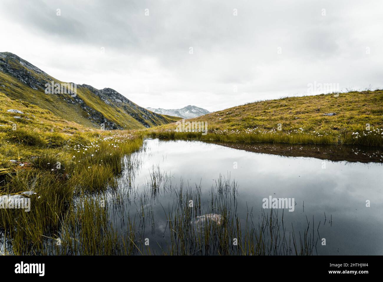 Landscape view of a lake and mountains under a gray cloudy sky Stock ...