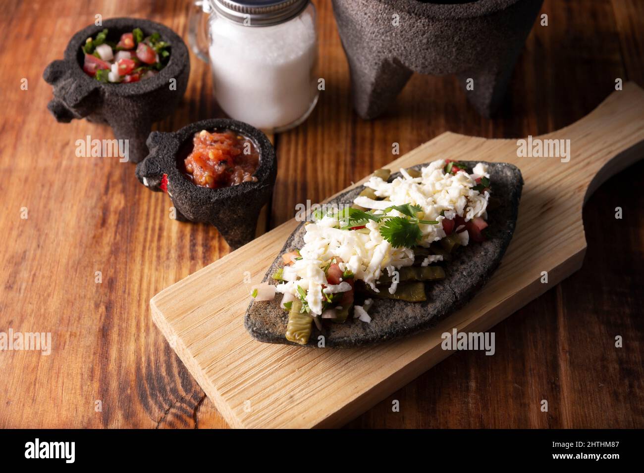 Tlacoyos with Nopales and salsa. Mexican pre hispanic dish made of blue ...