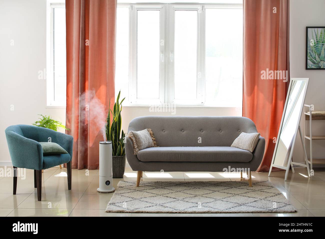 Interior of stylish living room with humidifier Stock Photo - Alamy