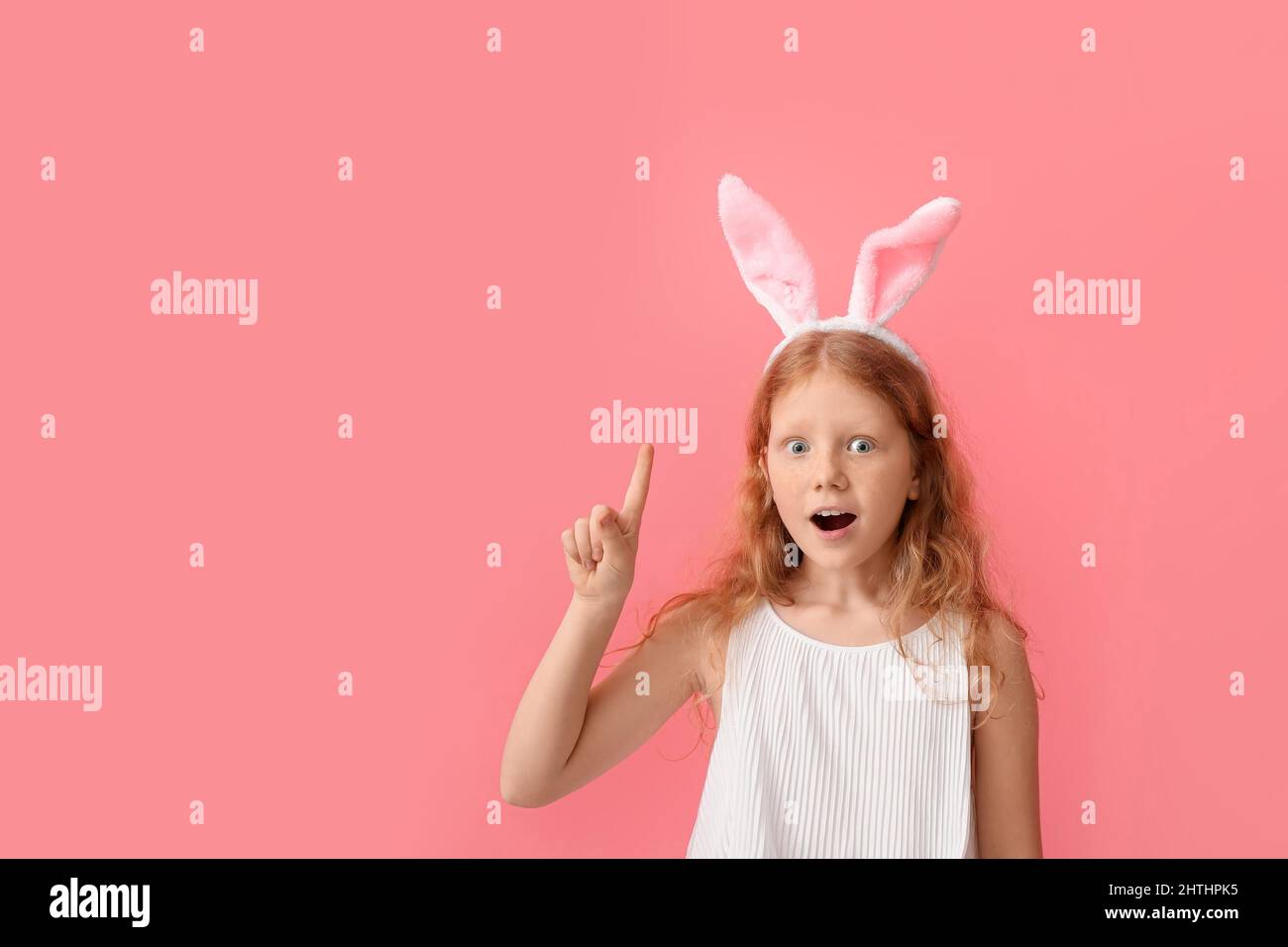 Funny Redhead Girl With Bunny Ears And Raised Index Finger On Color