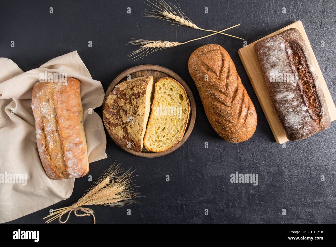 top view of the assortment of delicious baked bread of various shapes ...