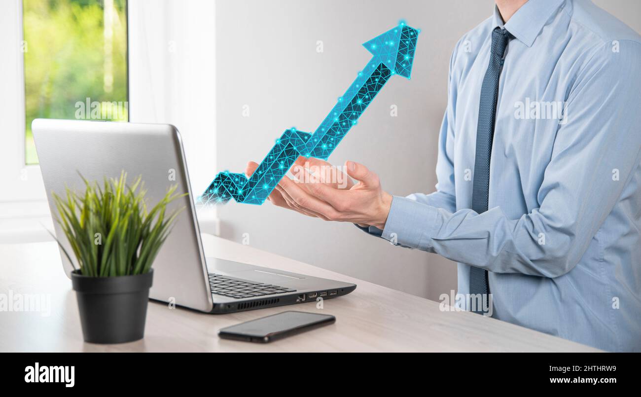 Businessman hold graph, arrow of positive growth icon.pointing at ...