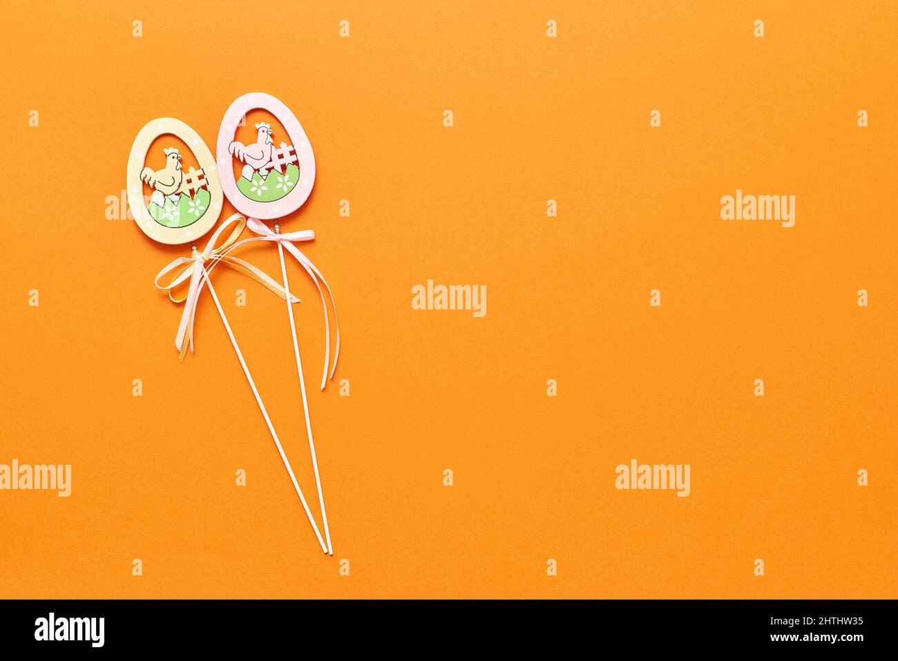 Easter decoration in the form of wooden eggs on a stick on a orange ...