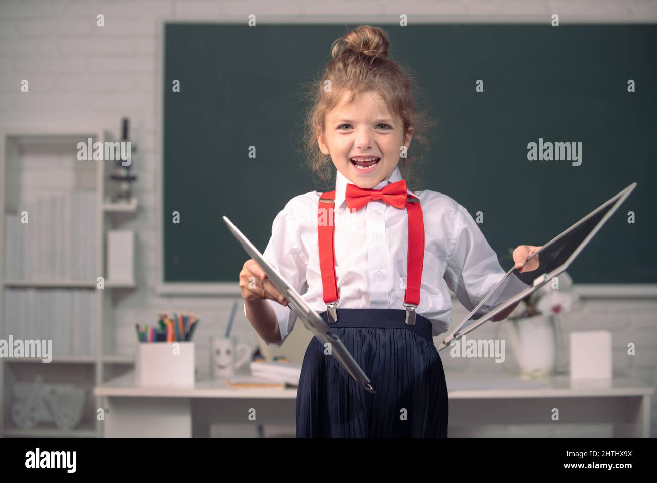 Bad Funny school girl vs distance education. Angry excited kid broken ...
