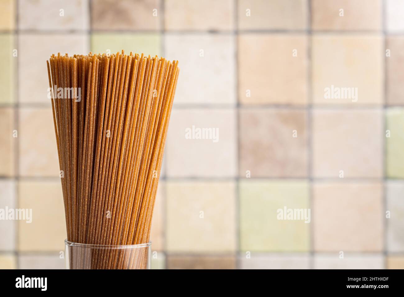 Uncooked whole grain spaghetti. Raw pasta in a cup Stock Photo - Alamy