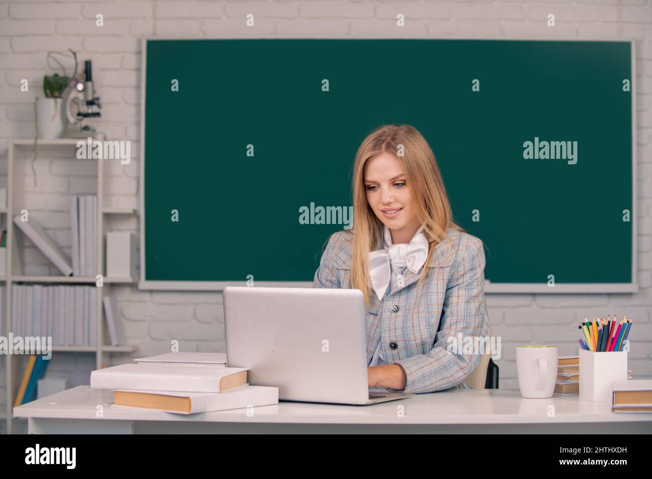 Young teacher. Focused student, young woman online watching webinar on ...