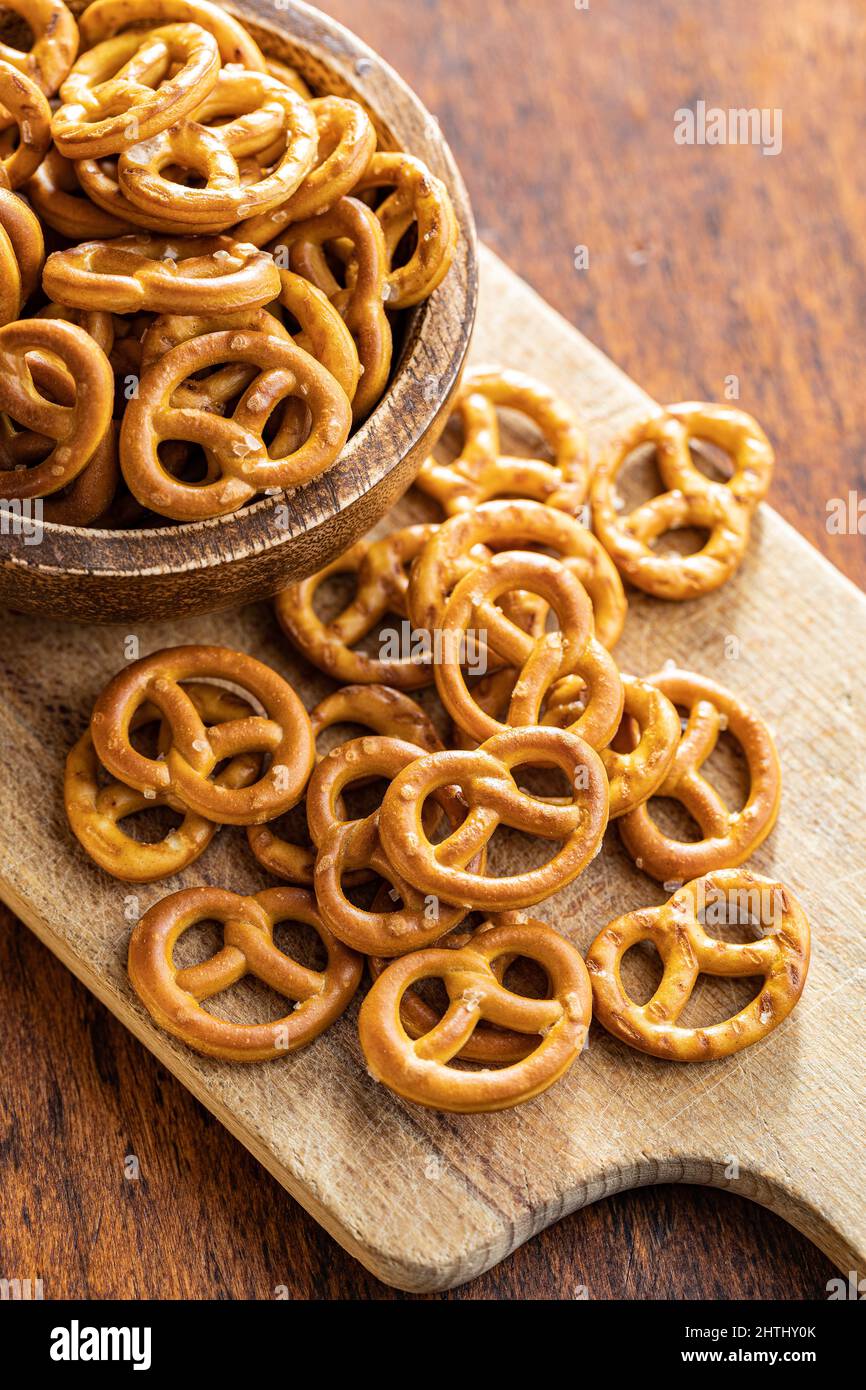 Mini pretzels. Crusty salted snack on a cutting board Stock Photo - Alamy