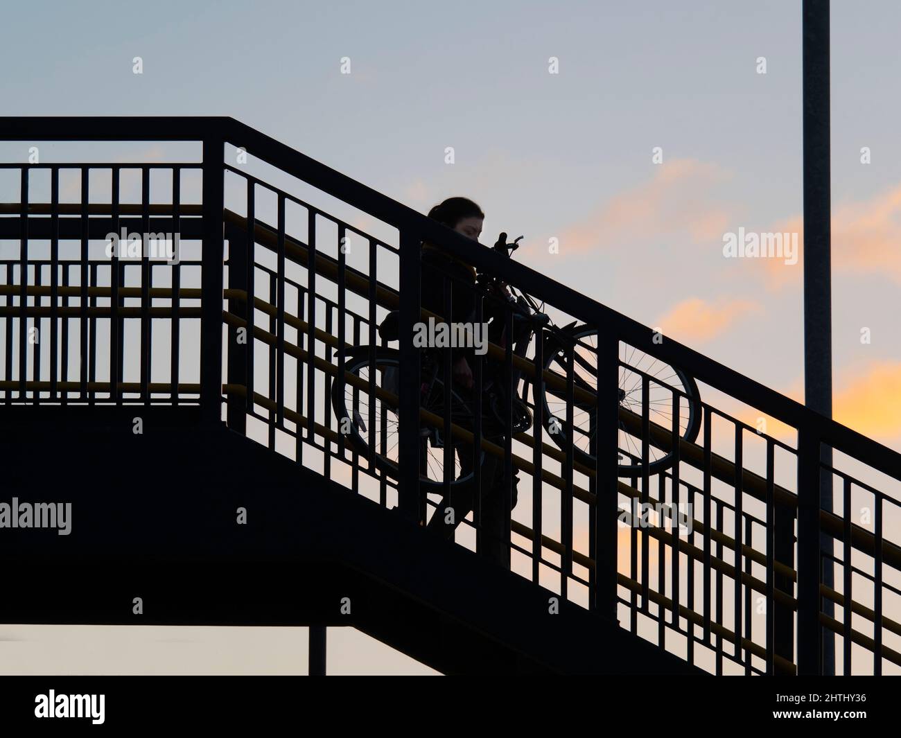Woman carrying bicycle over the Railway Bridge at Radley Station ...