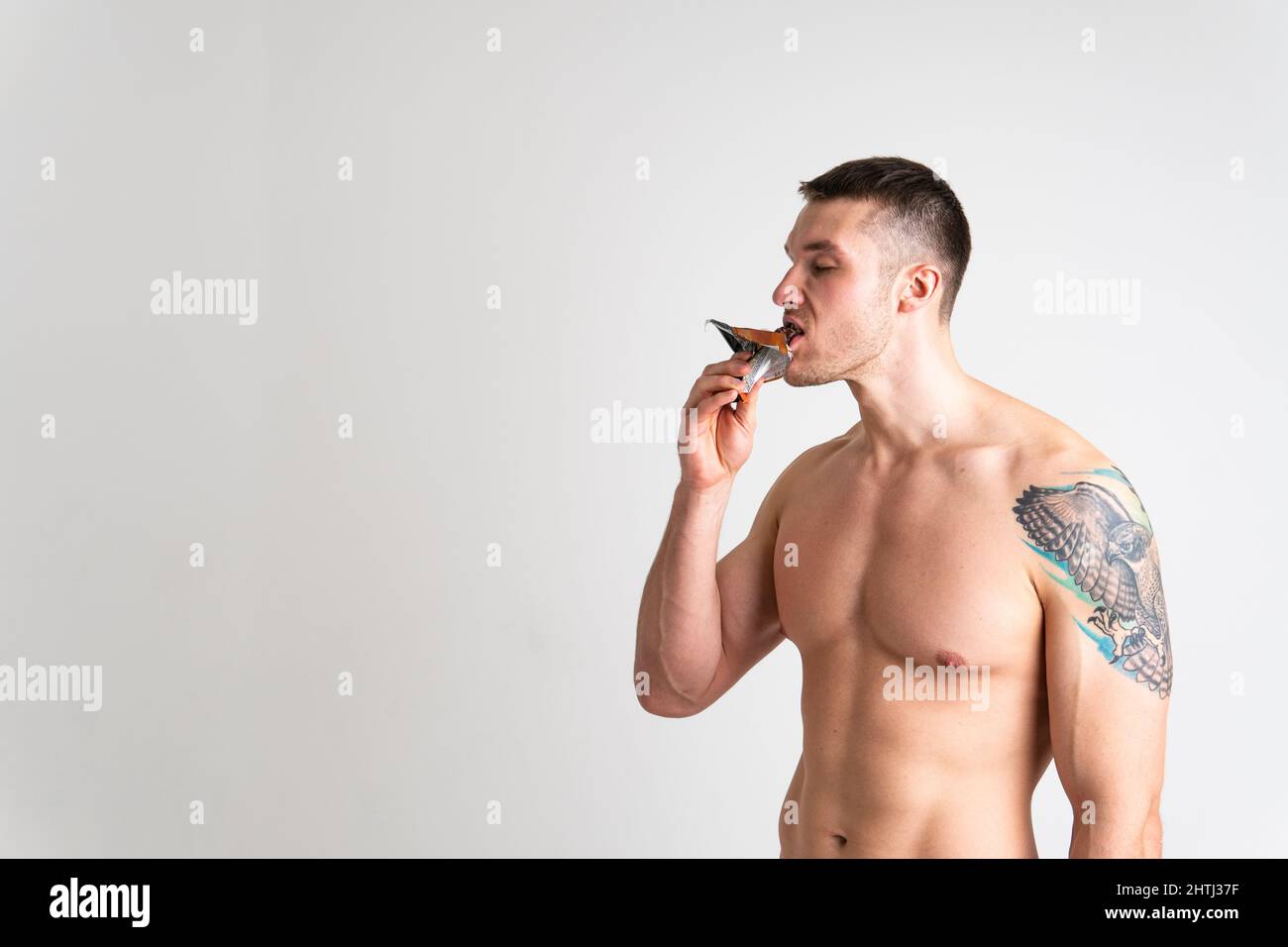 Man eats protein bar on white background isolated bar energy eat ...