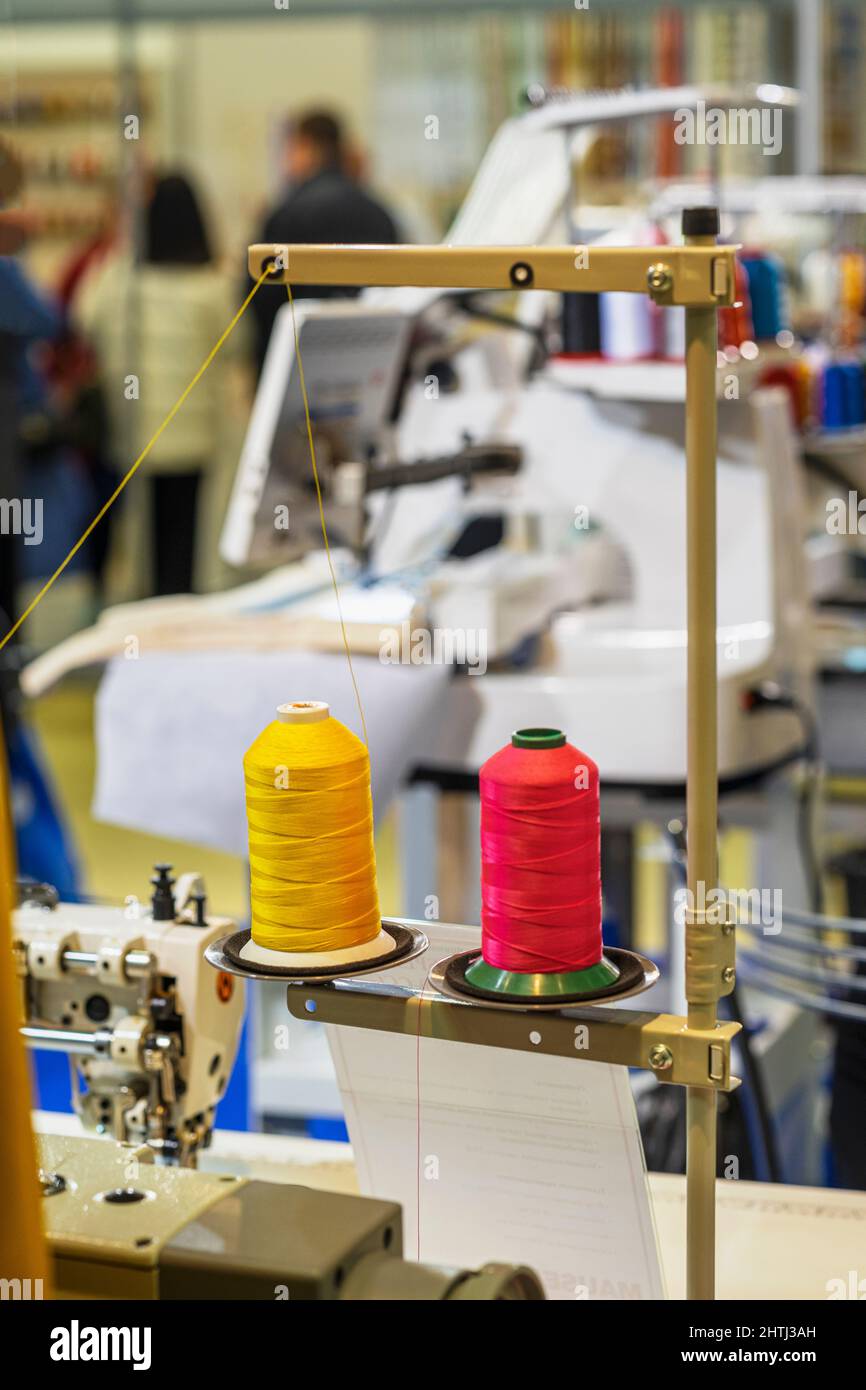 Colorful Spools of Thread on Sewing Equipment, nobody. Fabric and ...