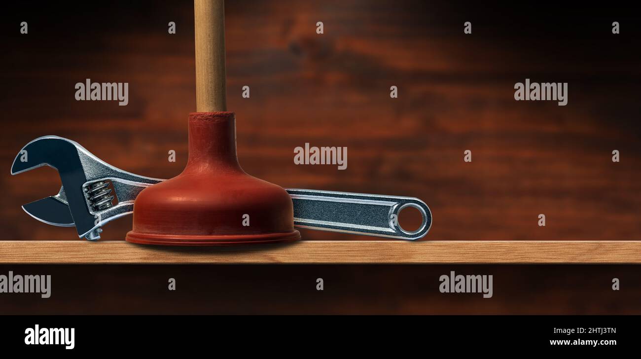 Close-up of a red rubber plunger with wooden handle and a modern ...