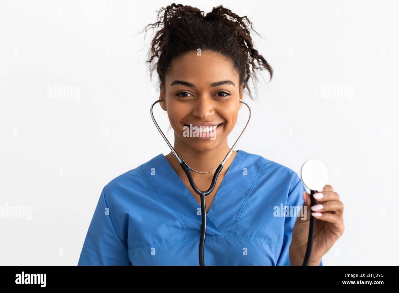 Portrait of black doctor smiling and showing stethoscope Stock Photo ...