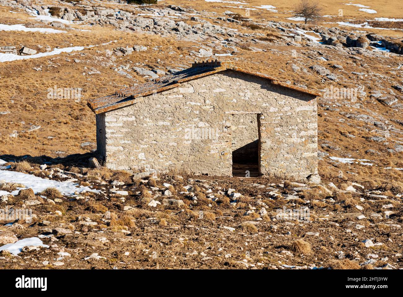 Old stone cow shed in winter with brown meadows, Lessinia Plateau ...