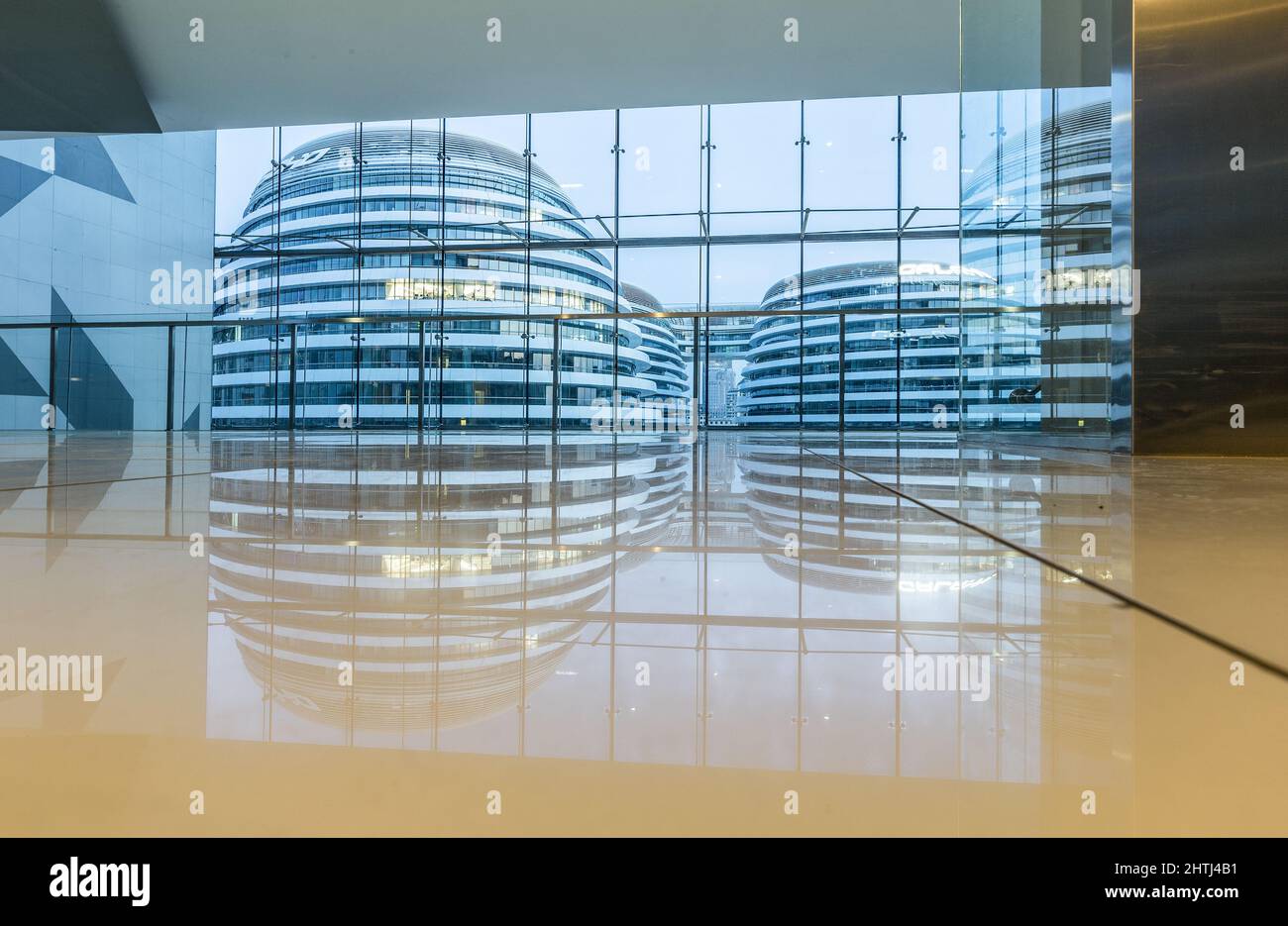 Fascinating shot of Galaxy SOHO Office Building behind the glass ...