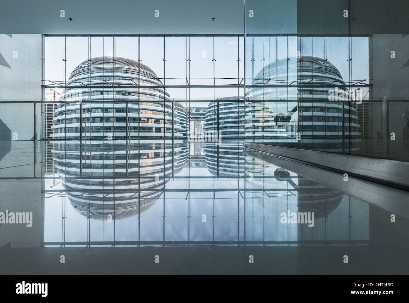 Fascinating shot of Galaxy SOHO Office Building behind the glass ...