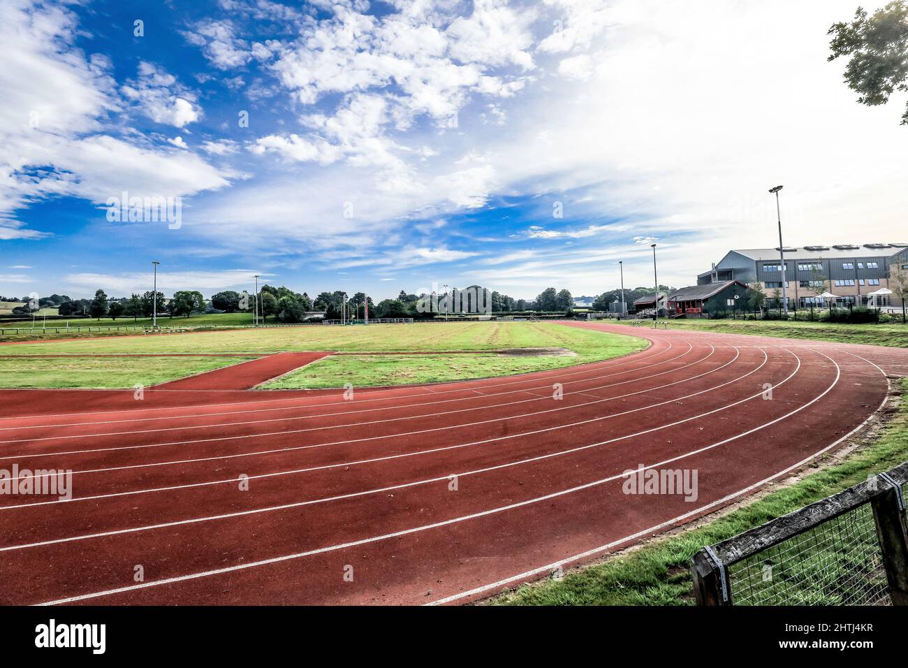 Red running track at a high school, ready for runners Stock Photo - Alamy