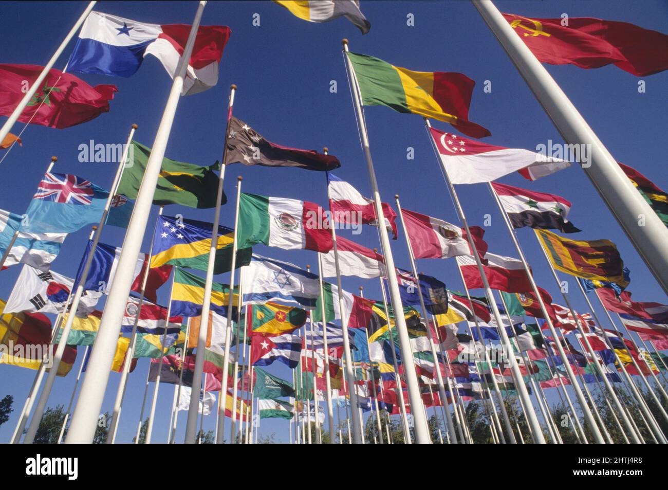 flags symbol around the world blue sky background Stock Photo - Alamy
