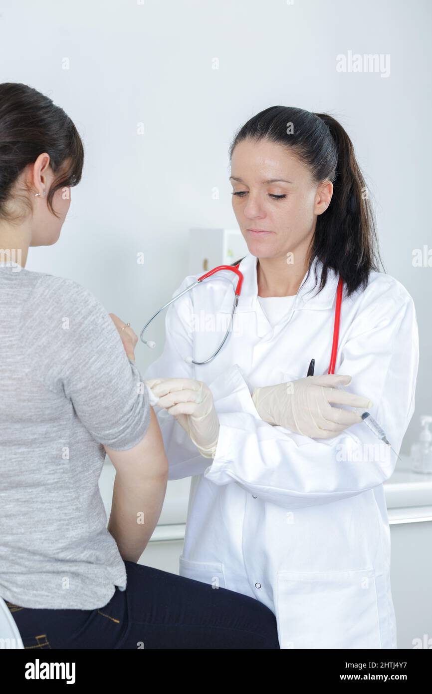 a doctor injecting patients hand Stock Photo - Alamy