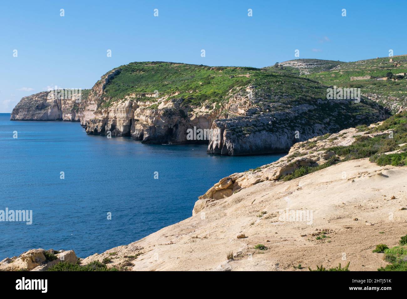 The bay and low cliffs of the drowned ria valley of Mgarr ix-Xini, in ...