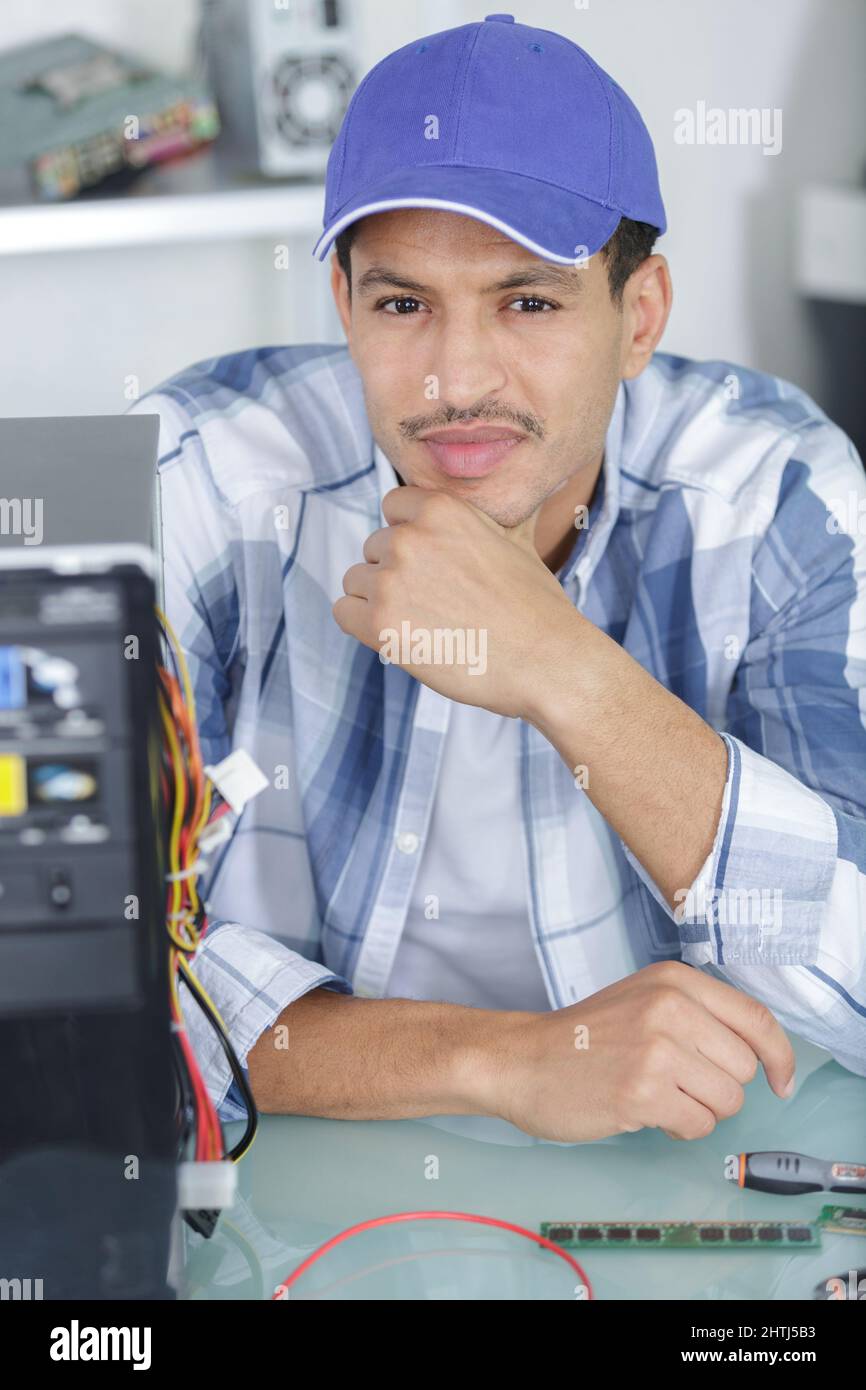 worker posing next to pc Stock Photo - Alamy
