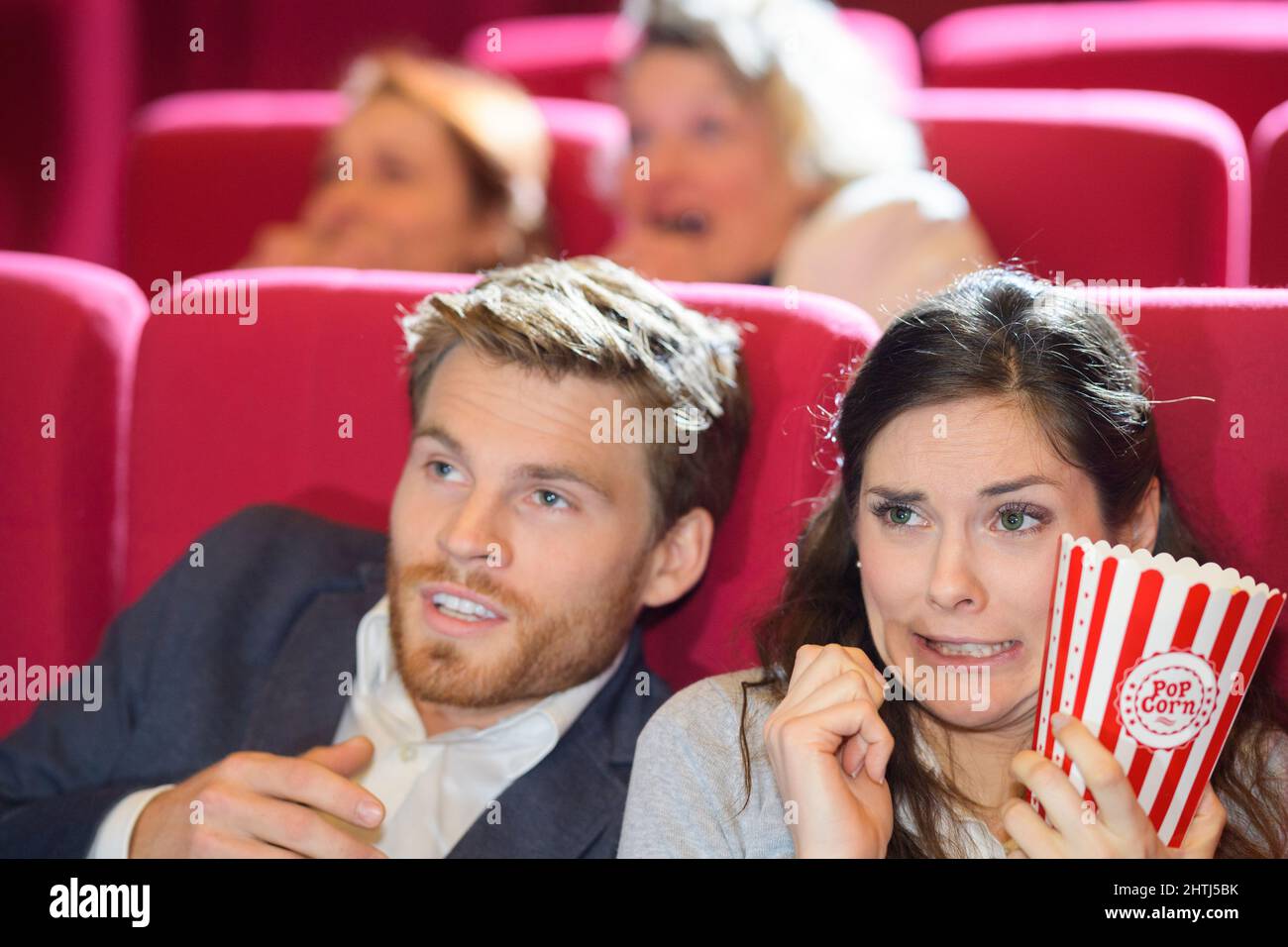 frightened couple watching film in the cinema Stock Photo - Alamy