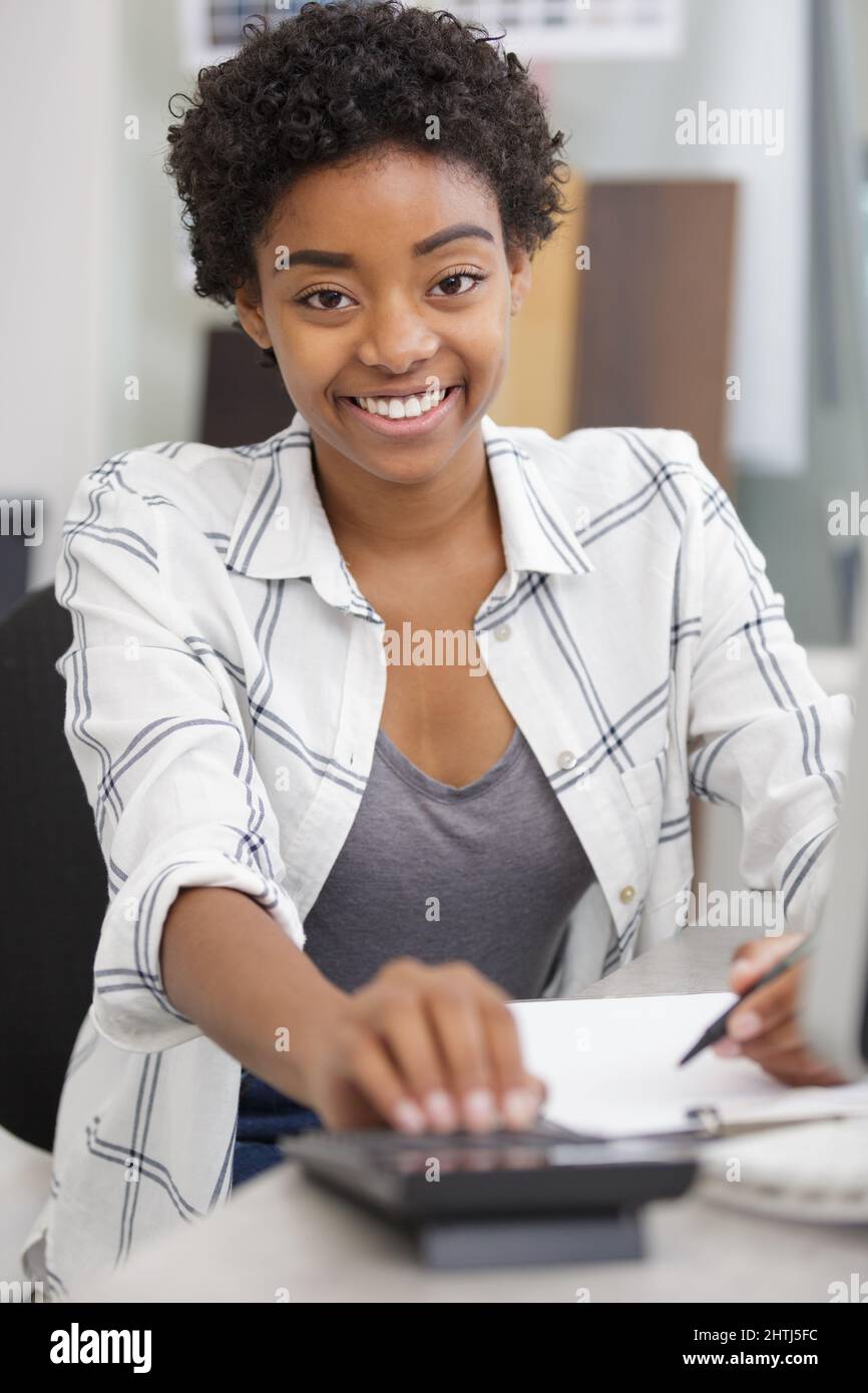 woman calculating invoice with calculator in office Stock Photo - Alamy