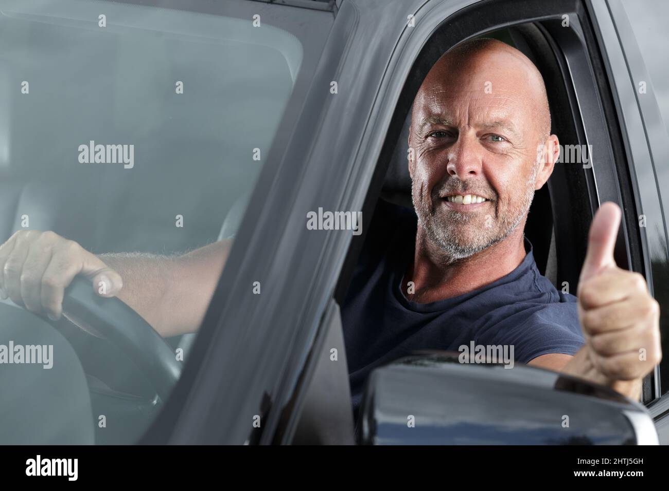 man in a car with thumbs up Stock Photo - Alamy