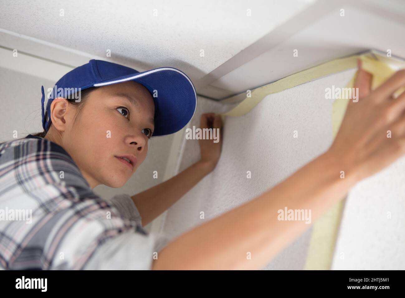 remove paper masking tape from after painting Stock Photo - Alamy