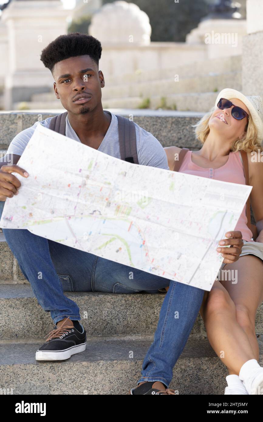 lovely mixed couple with a map Stock Photo - Alamy