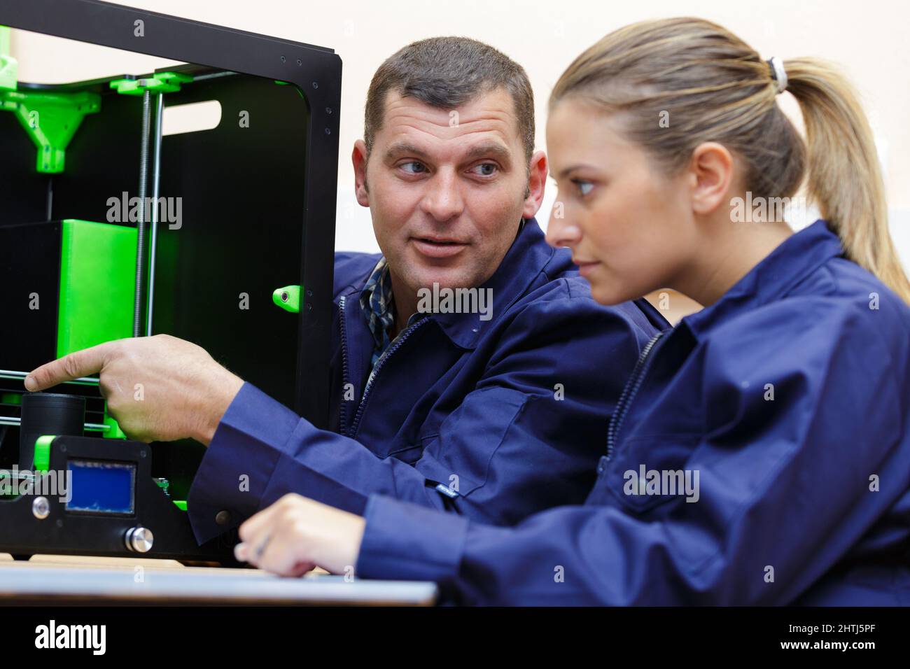 female material engineering apprentice pointing Stock Photo - Alamy