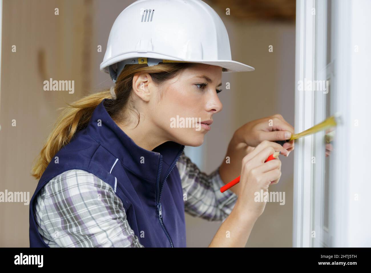 portrait of a woman measuring window frame Stock Photo - Alamy portrait of a woman measuring window frame Stock Photo - Alamy