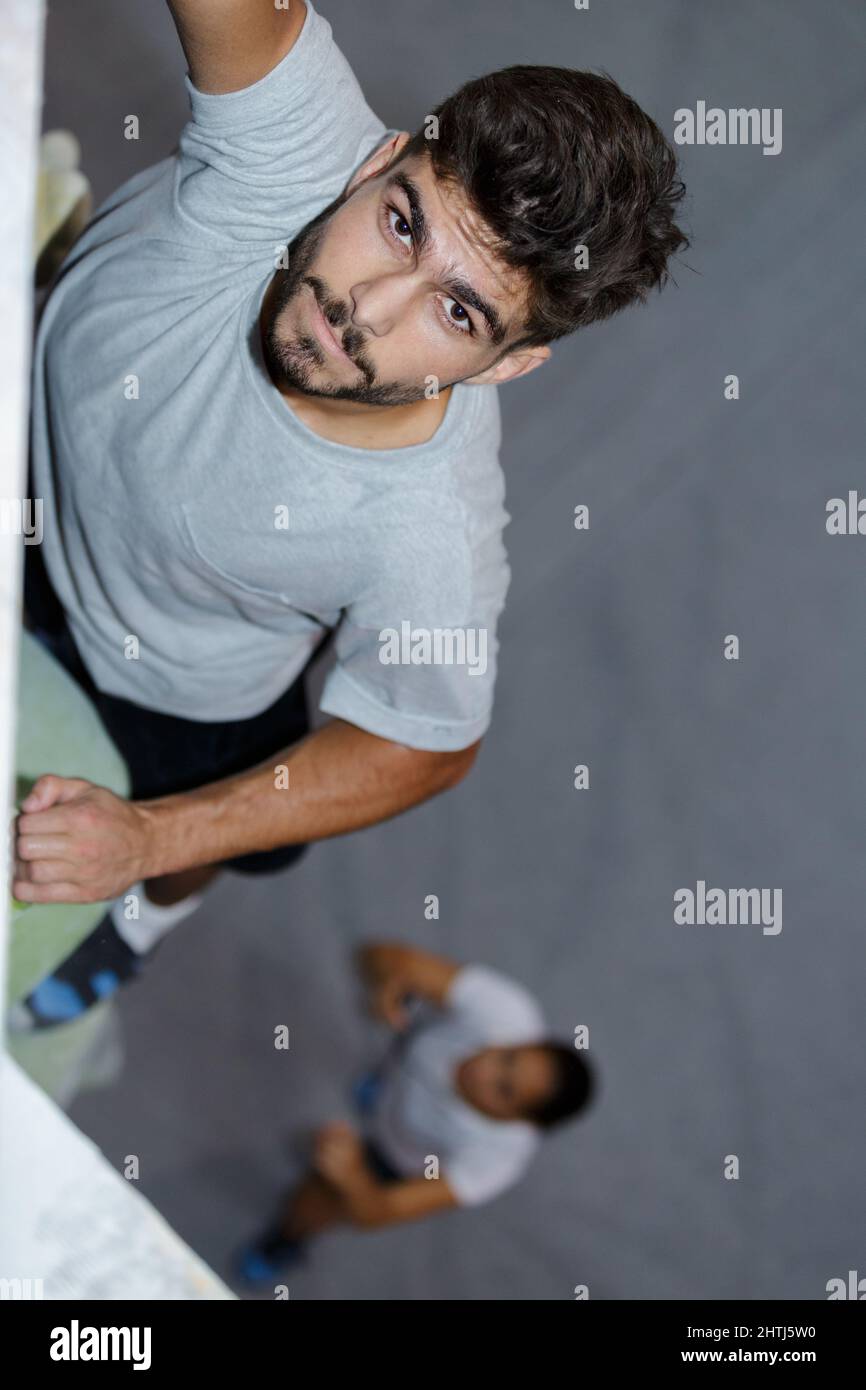 male wall climber on top Stock Photo - Alamy