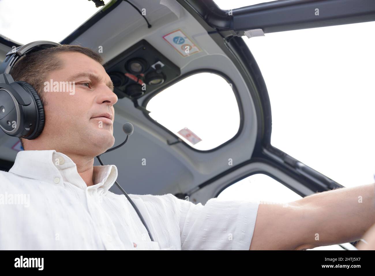 a concentrated helicopter pilot flying Stock Photo - Alamy