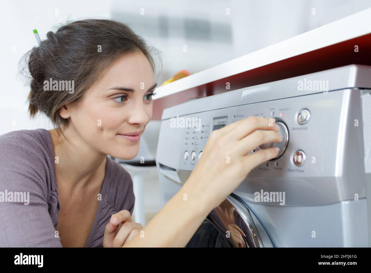 mother housewife loads a washing machine Stock Photo - Alamy