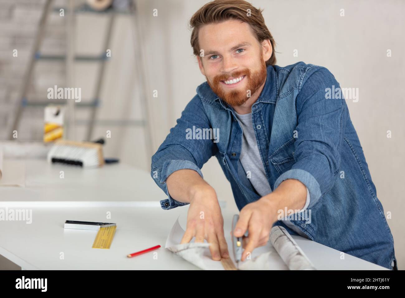 Handsome young carpenter measuring hi-res stock photography and images ...