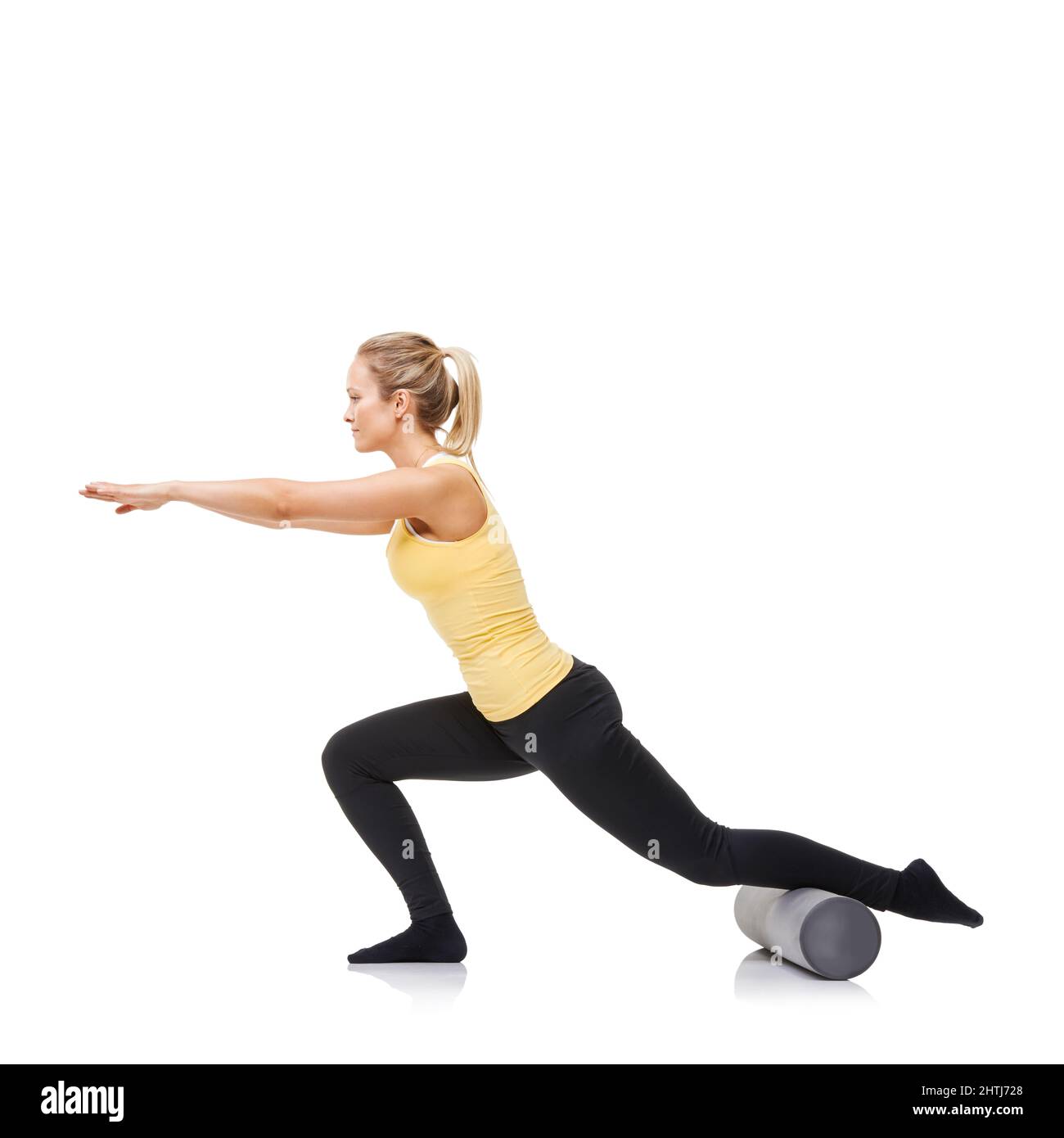 Working out her legs. A young woman performing lunges while using a ...