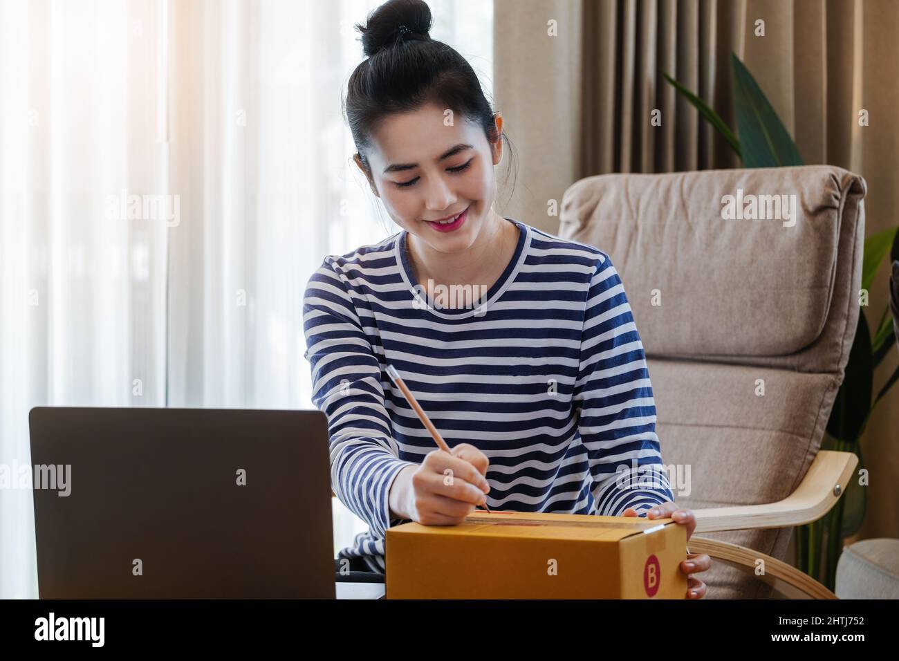 Online selling business idea, beautiful girl writing customer address ...